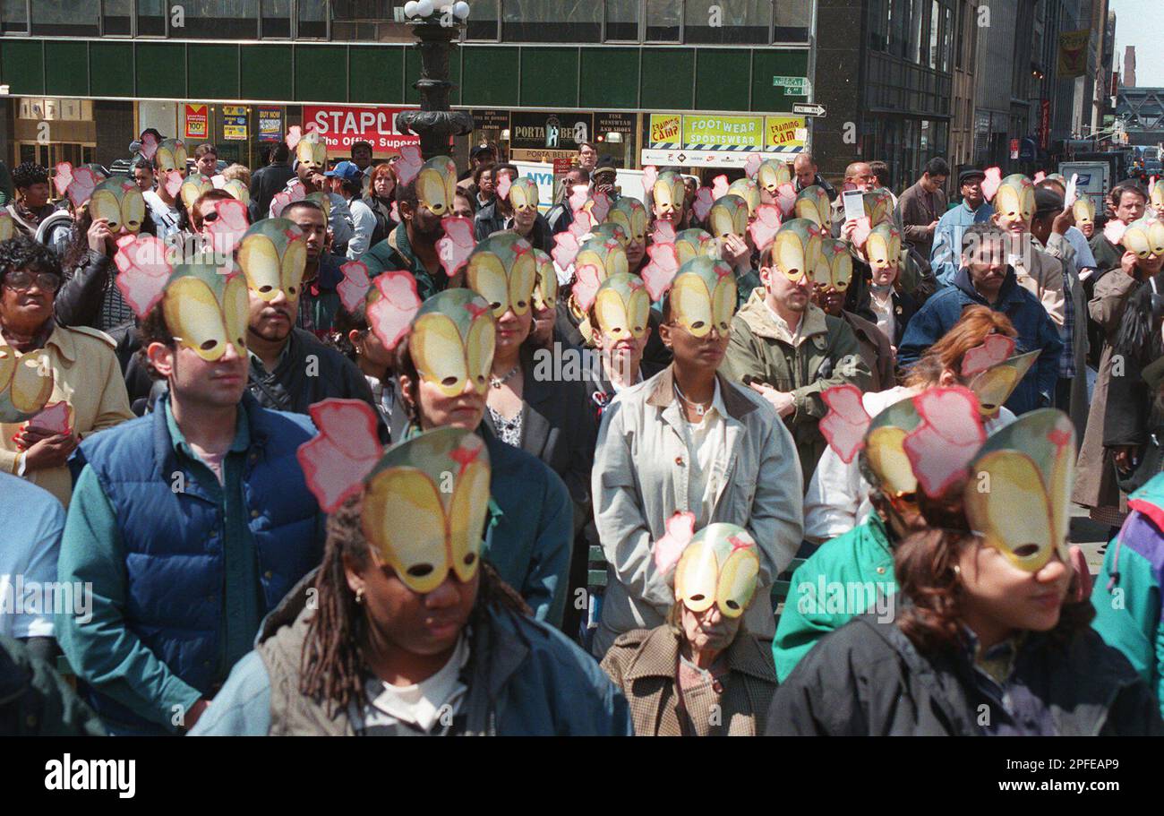 Survivors of violence wear masks as they gather during a rally in New ...