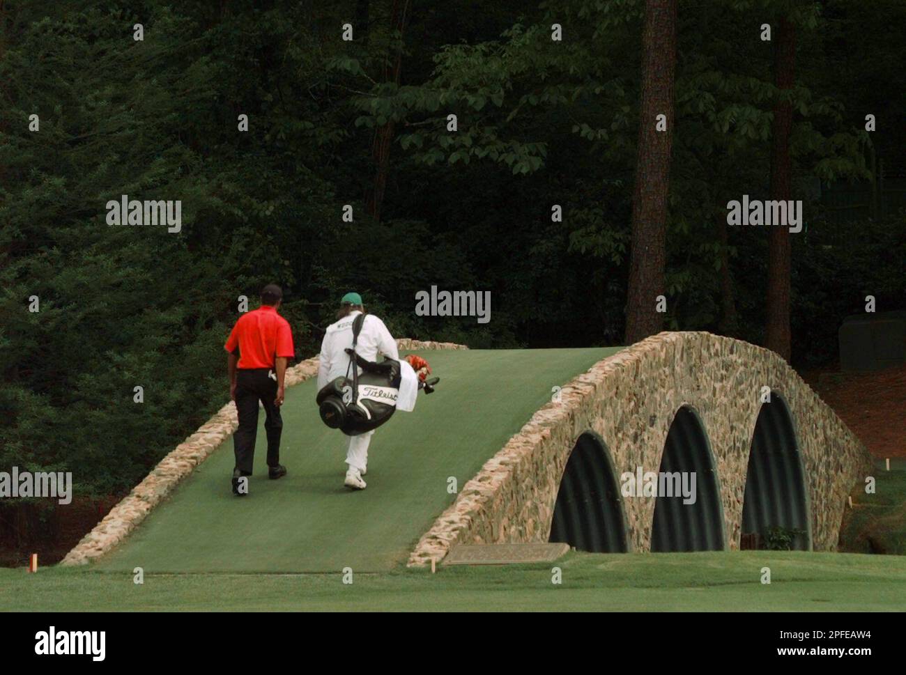 Tiger Woods crosses the Ben Hogan Bridge on the 12th hole with his ...