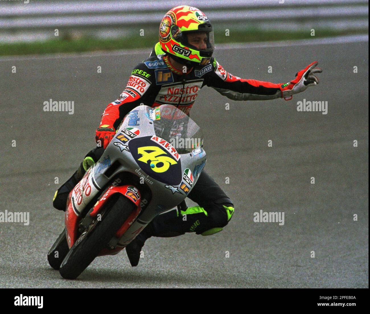 Valentino Rossi of Italy waves to the crowd while riding his victory ...