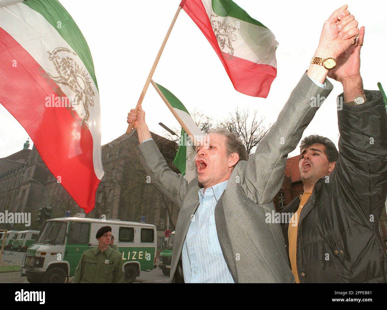 Unidentified Iranian dissidents with the former imperial flag cheer in ...