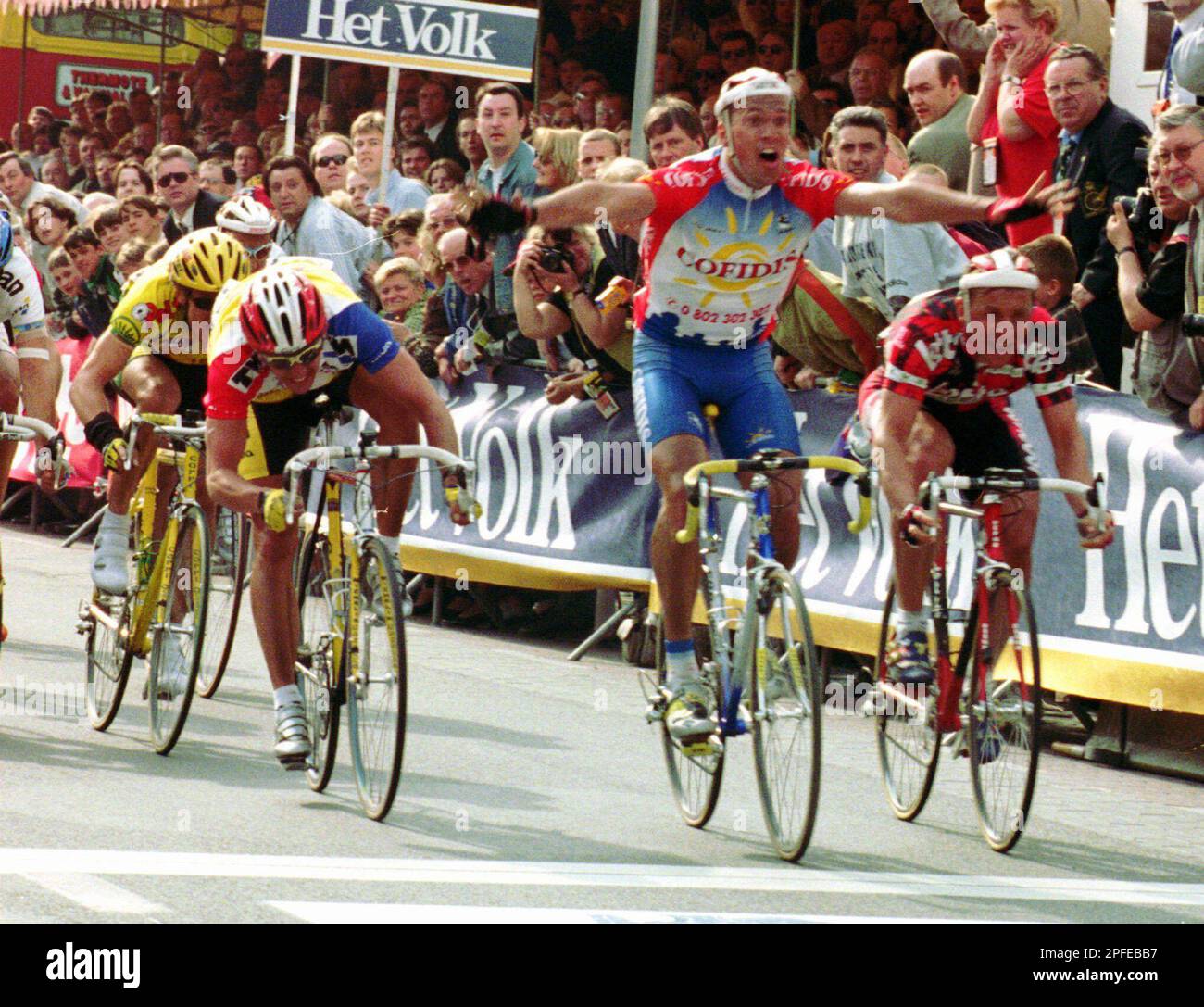 French Philippe Gaumont raises arms while crossing the finish line to ...