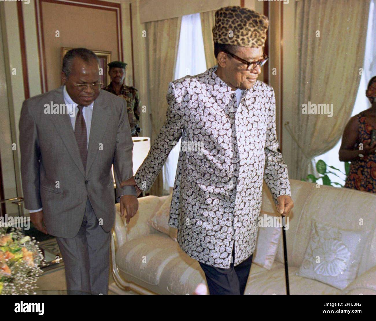Zairian President Mobutu Sese Seko, right, takes the hand of Etienne ...