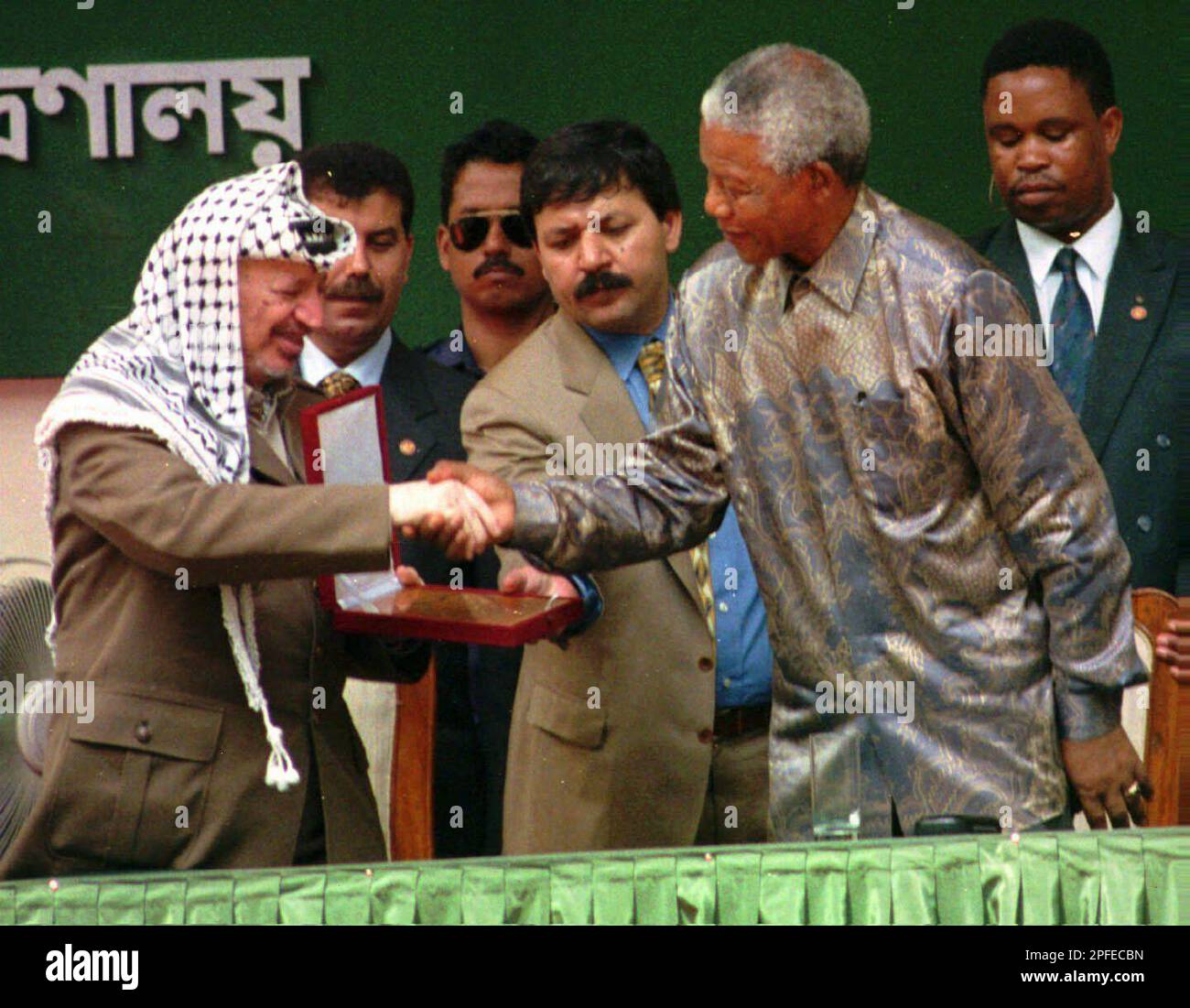 South African President Nelson Mandela, right, shakes hands with ...