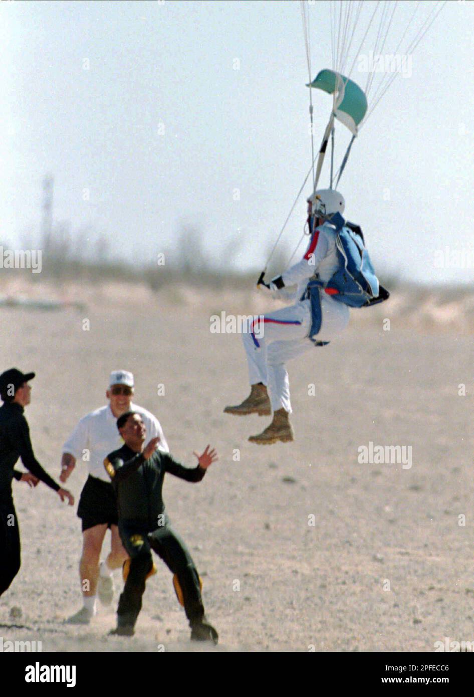 Former President George Bush prepares to land as members of his jump ...