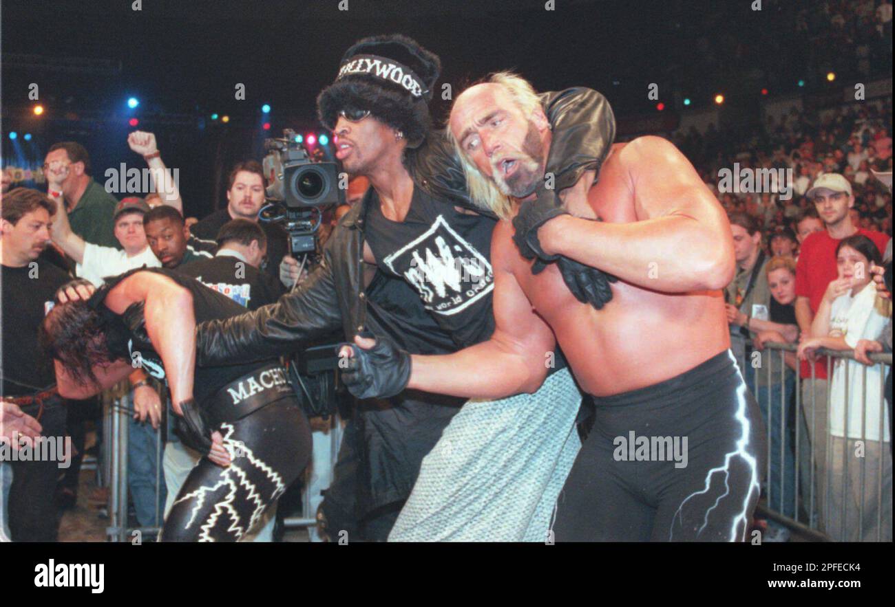 Basketball star Dennis Rodman, center, helps his wrestling tag team ...