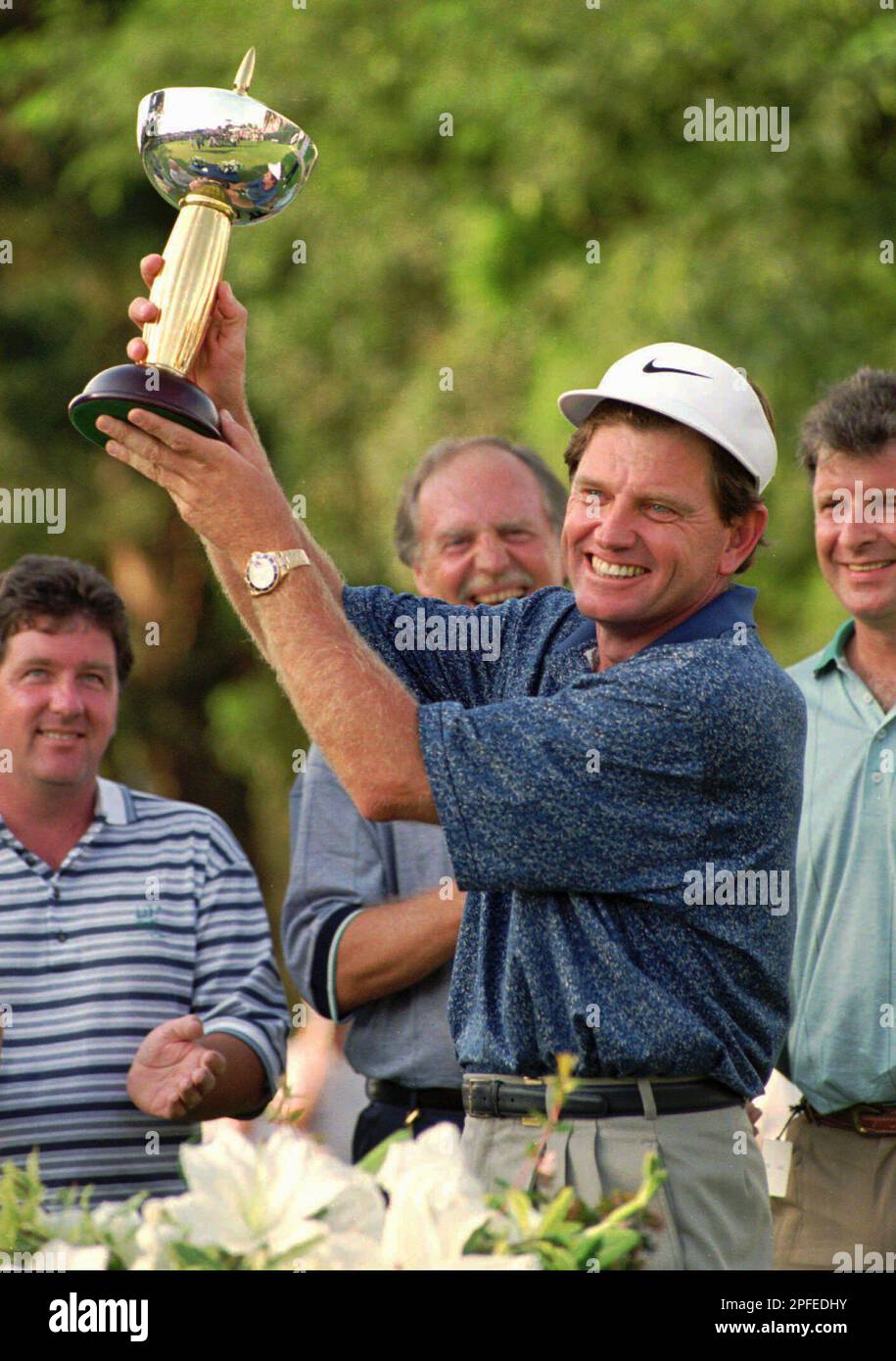 A delighted Nick Price of Zimbabwe, raises the winners trophy Sunday ...