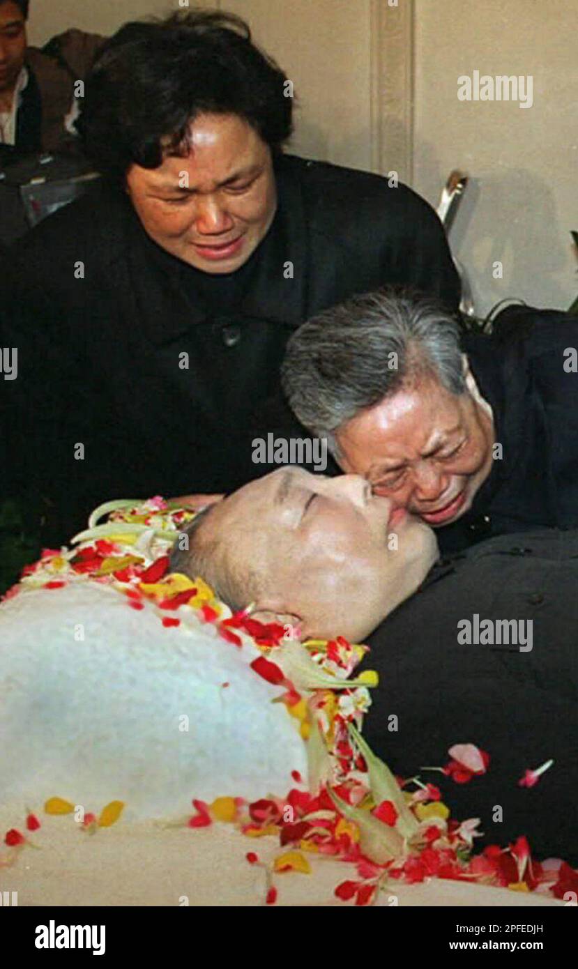 Widow Zhuo Lin kisses her husband Deng Xiaoping as she paid her final respects at the General ...