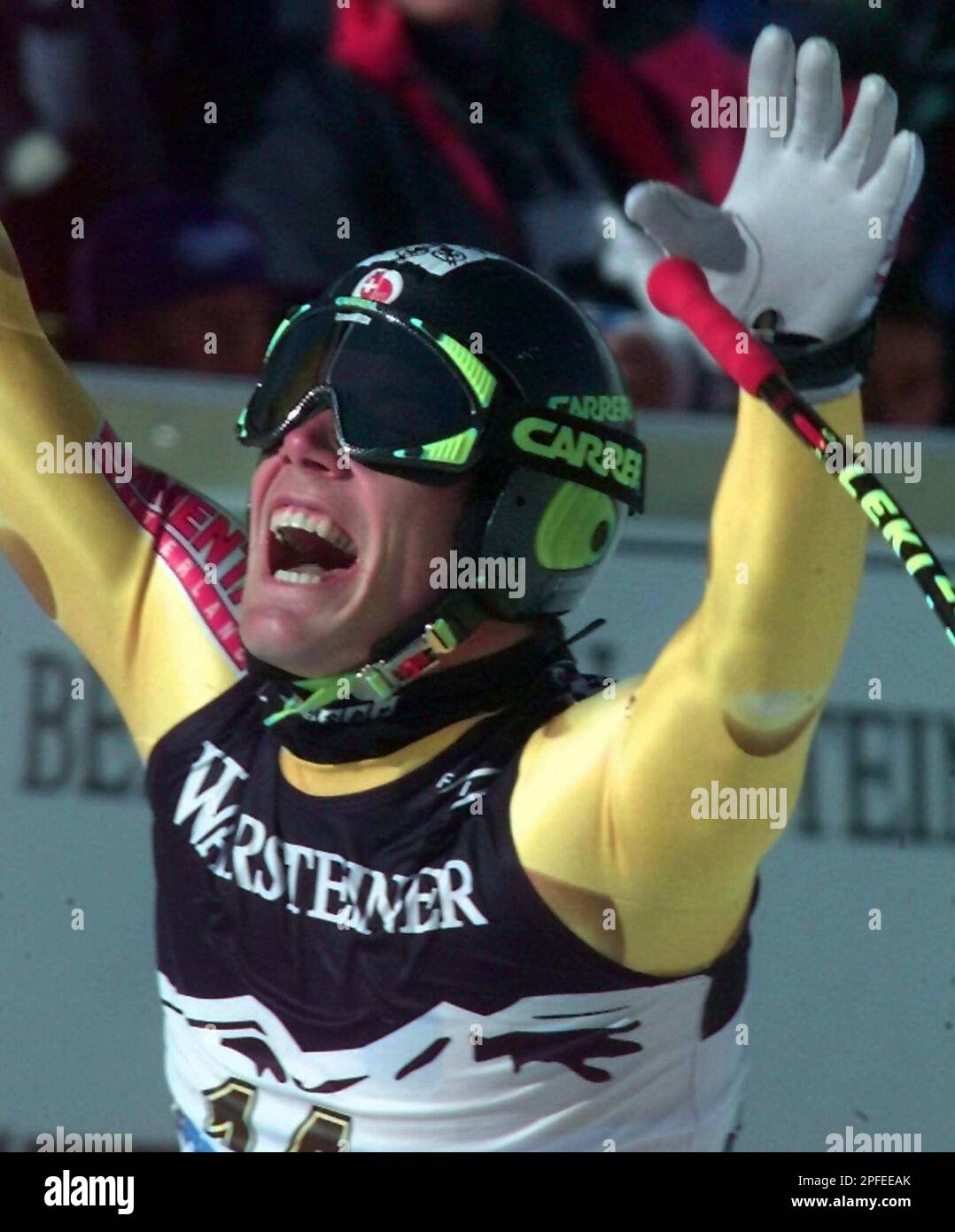 Bruno Kernen of Switzerland celebrates after crossing the finish line ...