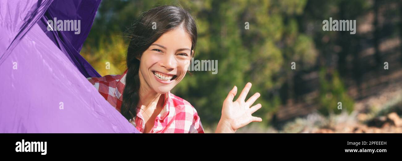 Happy camper in tent saying hello camping in forest banner panorama ...