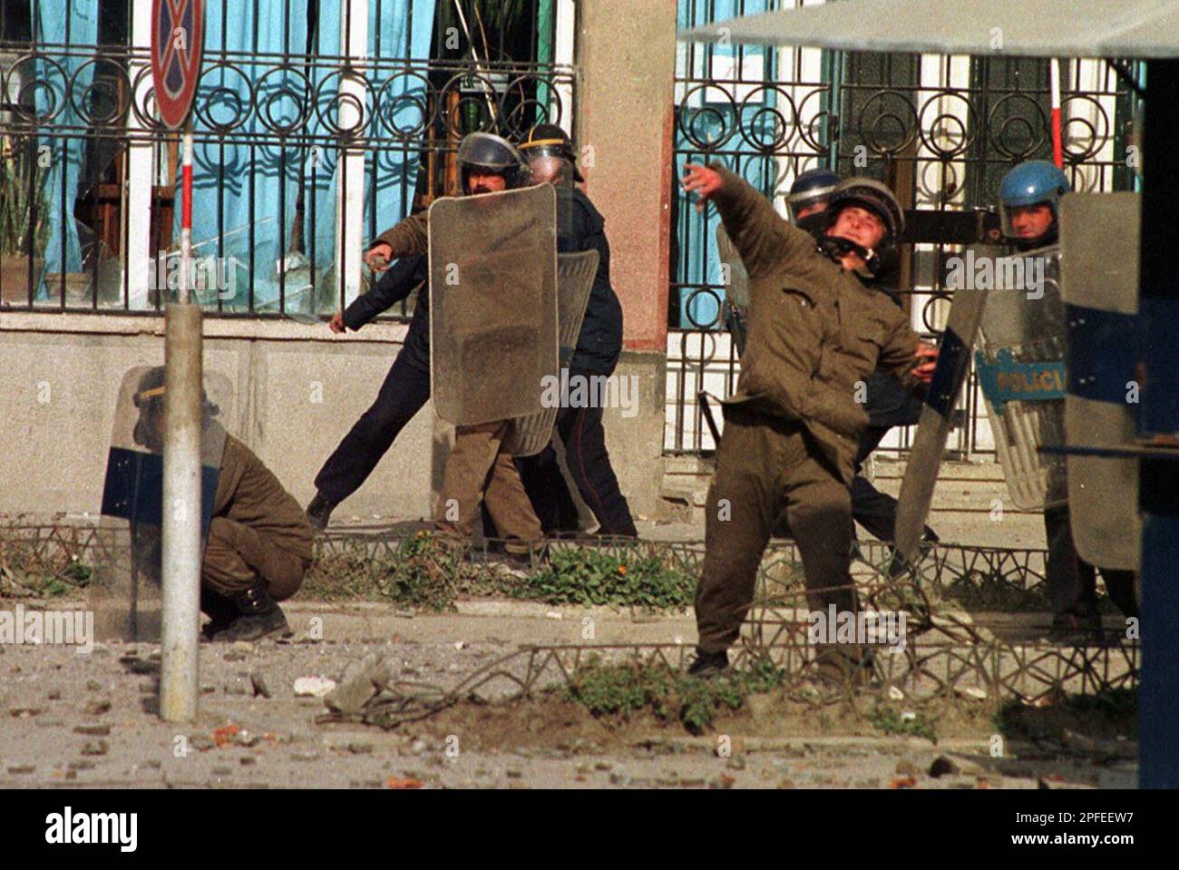 Albanian riot police throw rocks towards protesters in Lushnja, 85 ...