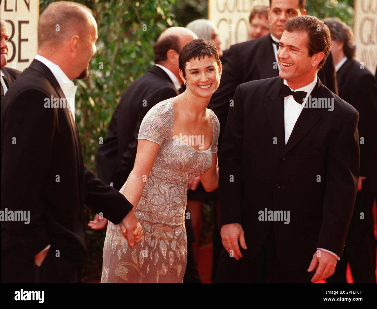 Actor Mel Gibson, right, greets actress Demi Moore and her husband ...