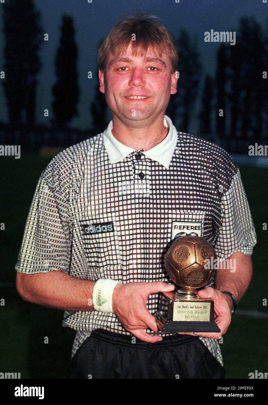 FILE - Hungarian soccer referee Sandor Puhl smiles as he holds the ...