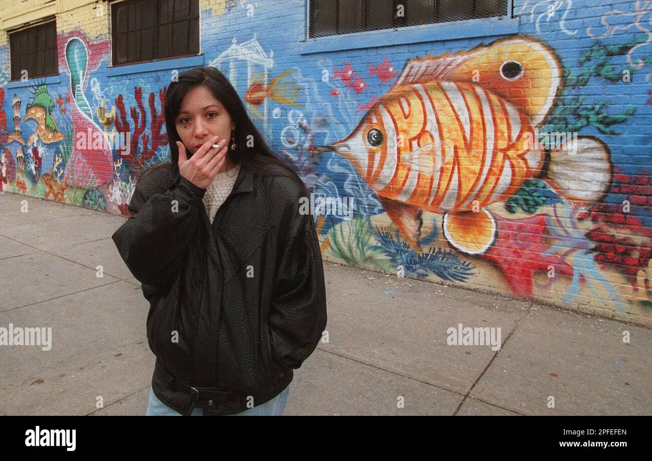 Graffiti artist Lady Pink poses in front of one of her murals in the ...