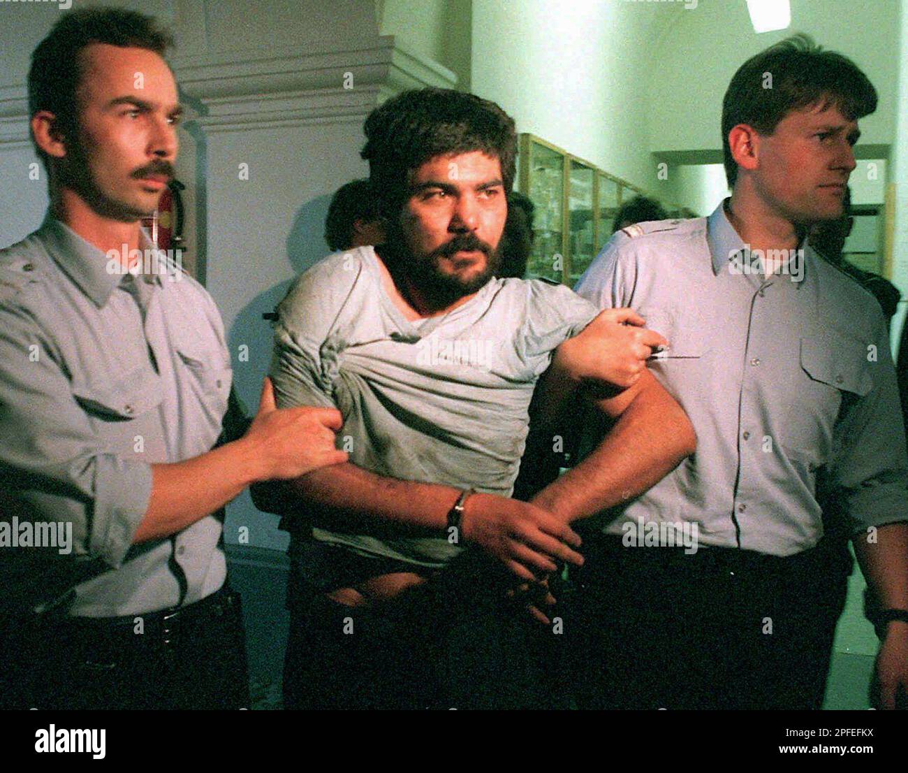 FILE--Prison guards take away Palestinian terrorist Tawfik ben Ahmed ...