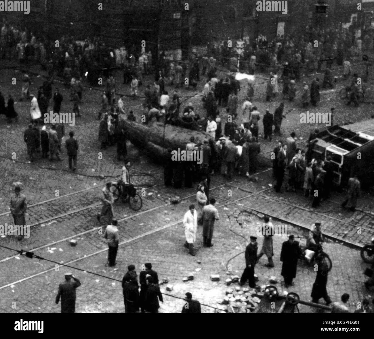 This October 29, 1956 photo shows angry people destroying a huge statue ...