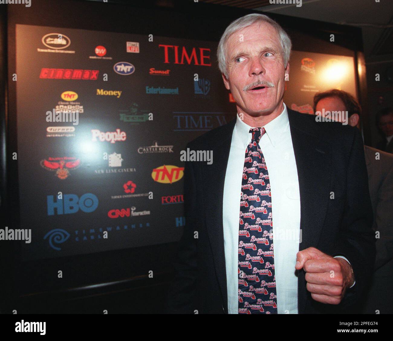 Ted Turner, new vice chairman of Time Warner Inc., pumps his fist as he ...