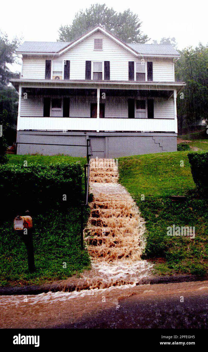 Heavy rain runs down this home's walkway Friday, Sept. 6, 1996 in ...