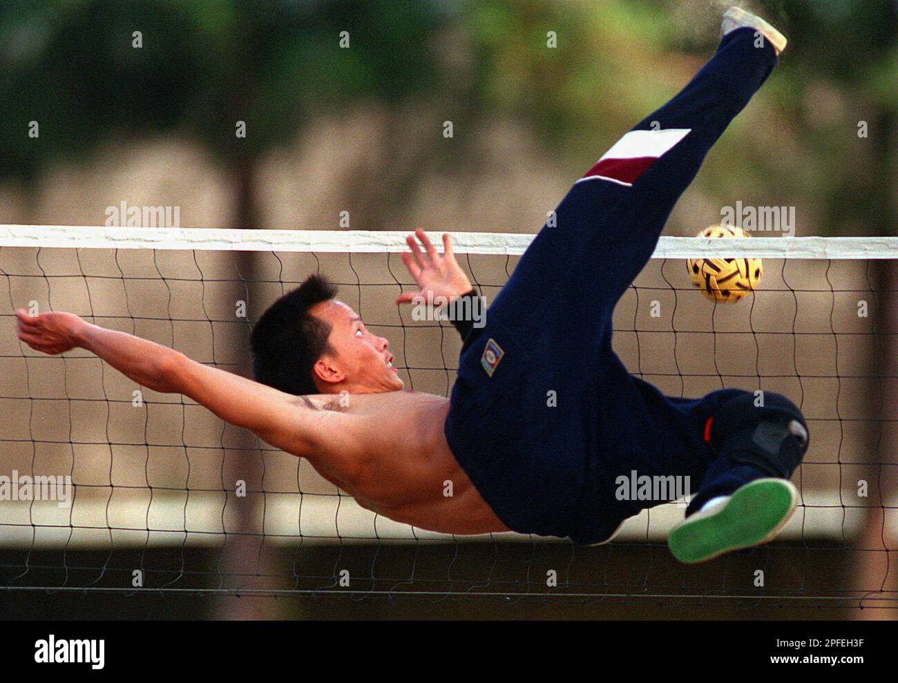 Ma Her spikes the ball during a game of takrow at a park in Fresno ...