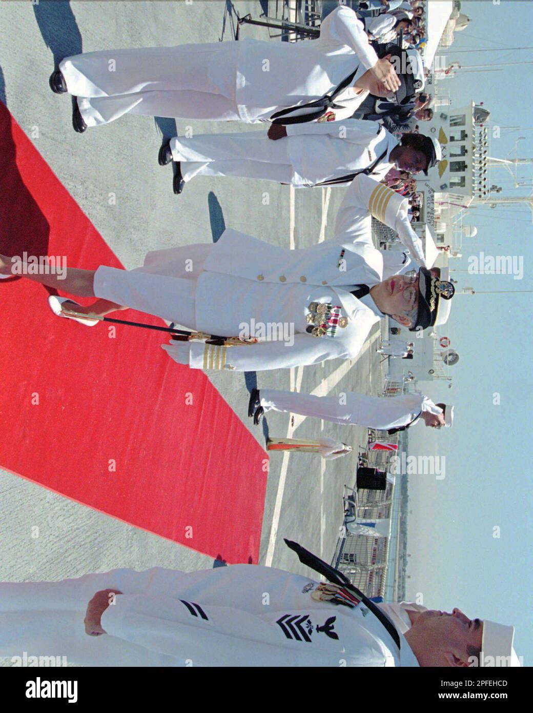 United States Navy Captain Jenny Martinez, center, returns the salutes ...