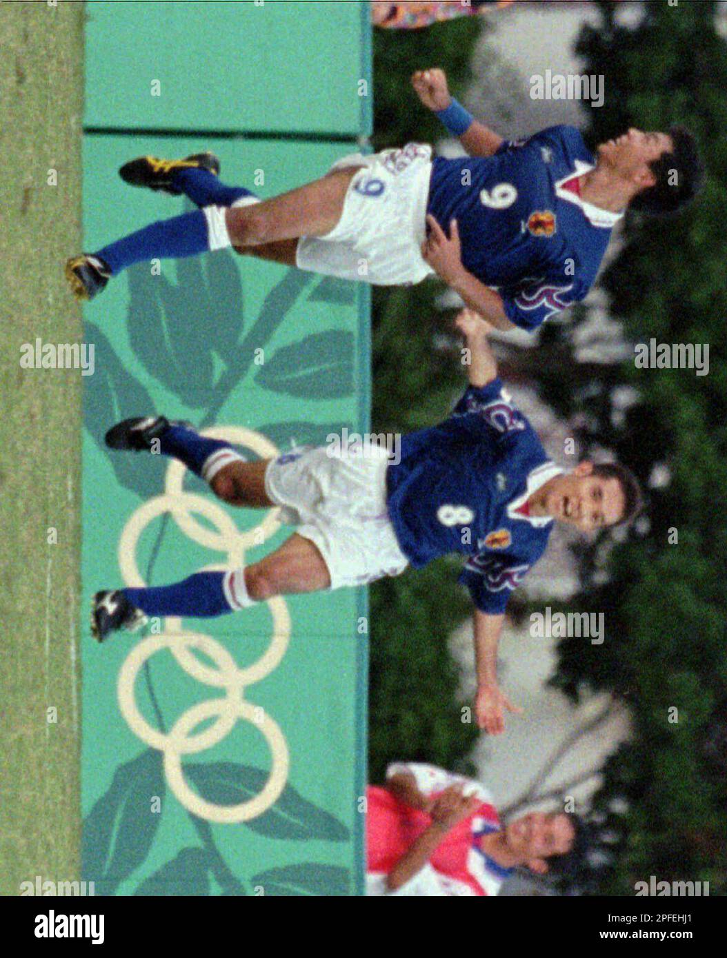 Midfielder Teruyoshi Ito (8) of Japan, right, spreads his arms as his ...