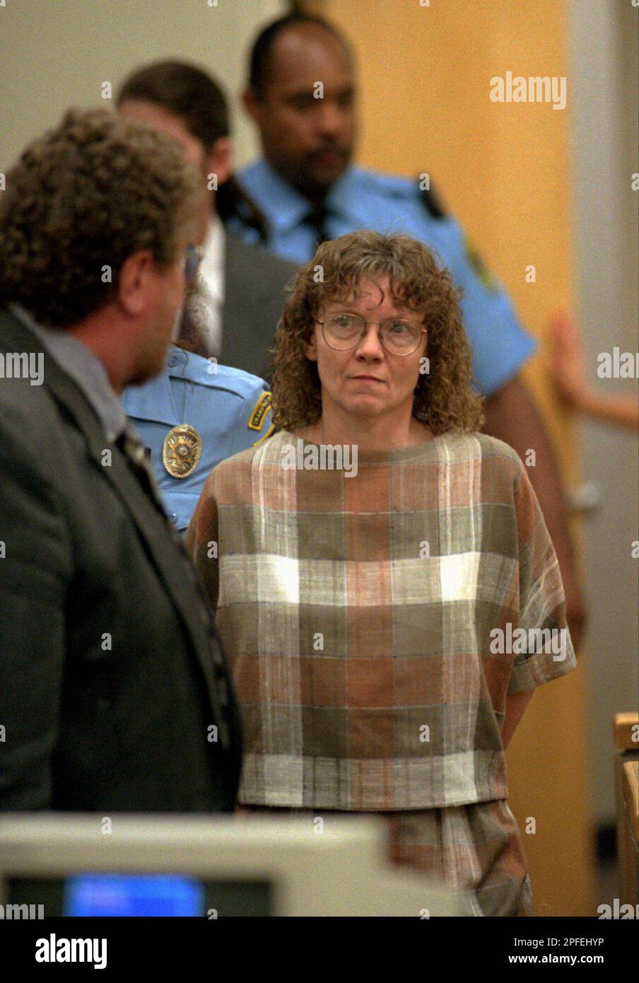 Esther Beckley is led into state District Court in Albuquerque, N.M ...