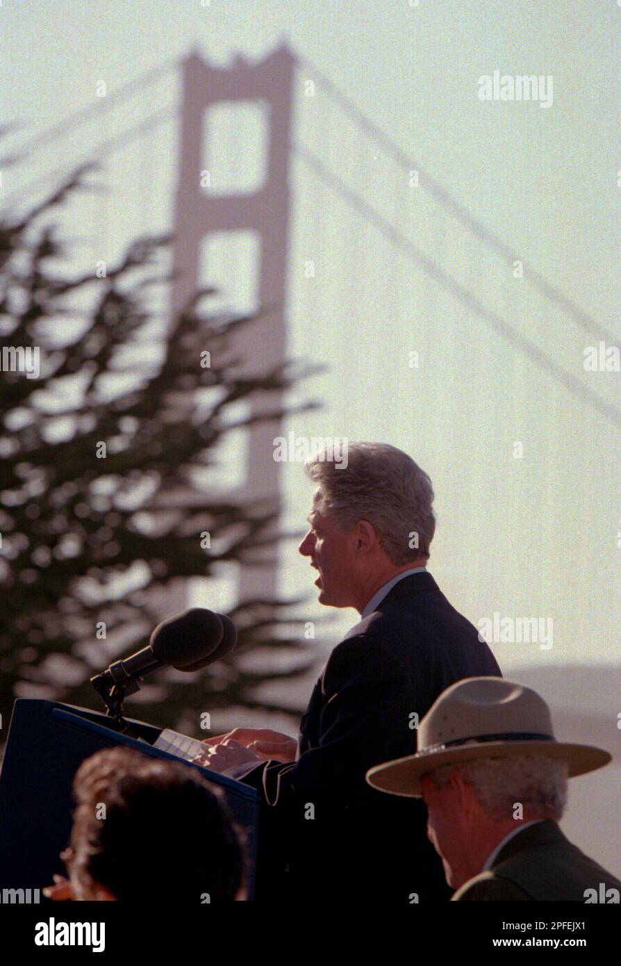 President Clinton is silhouetted with the Golden Gate Bridge behind him ...