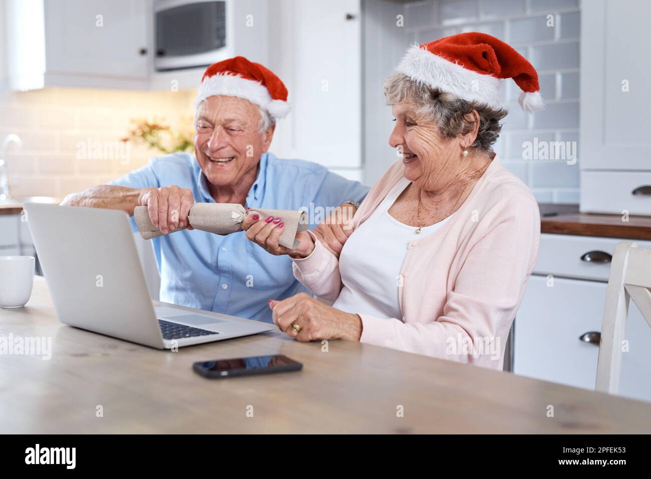 Lets exchange experience. an elderly couple holding a festive prop at ...