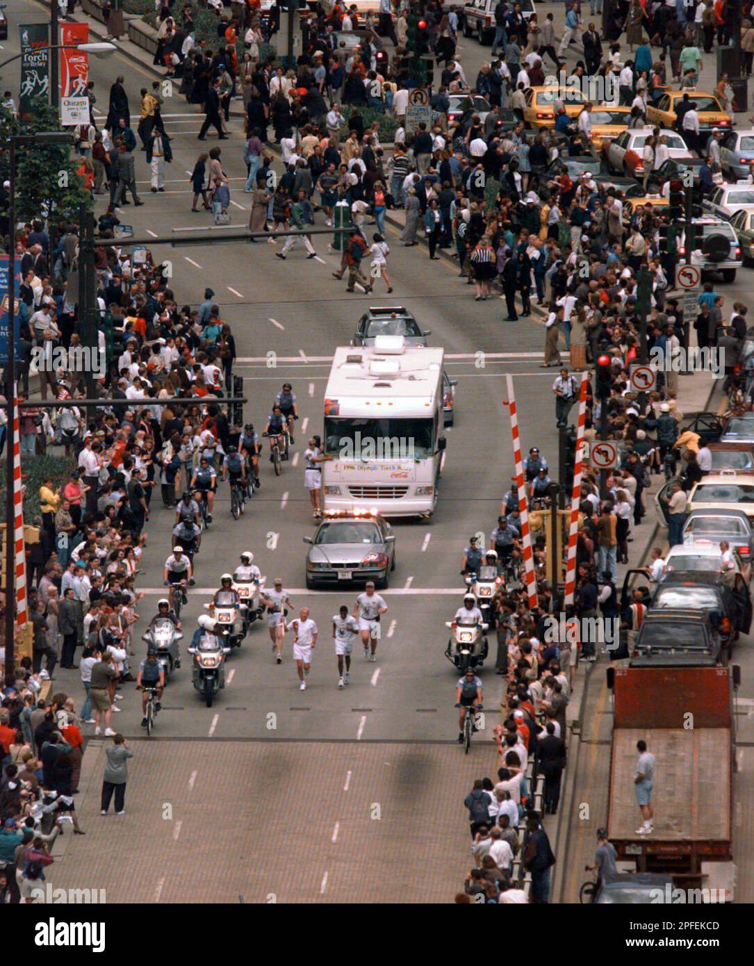 Post-lunchtime crowds line Michigan Ave. as the Olympic torch makes its ...