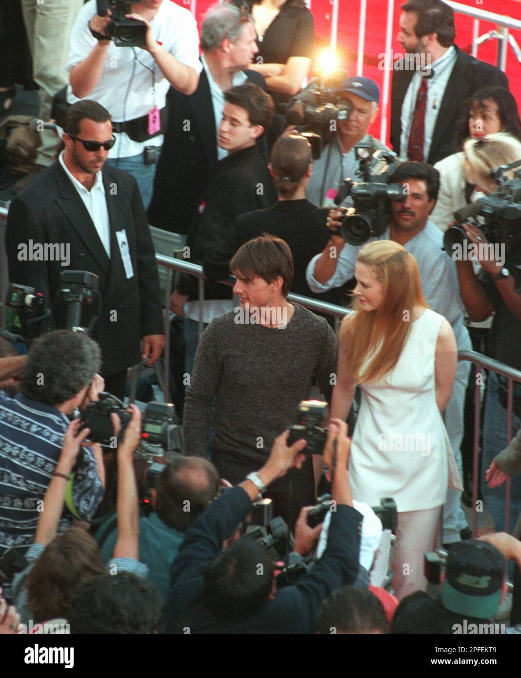 Tom Cruise, center, star of the new film "Mission: Impossible," strolls ...