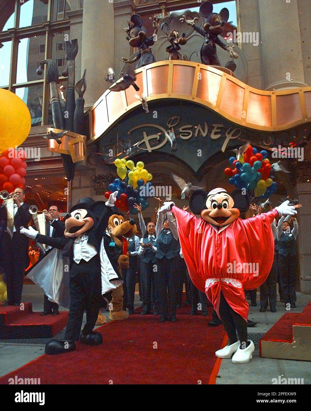 Mickey and Minnie Mouse, Pluto, trumpeters and flying doves help mark ...