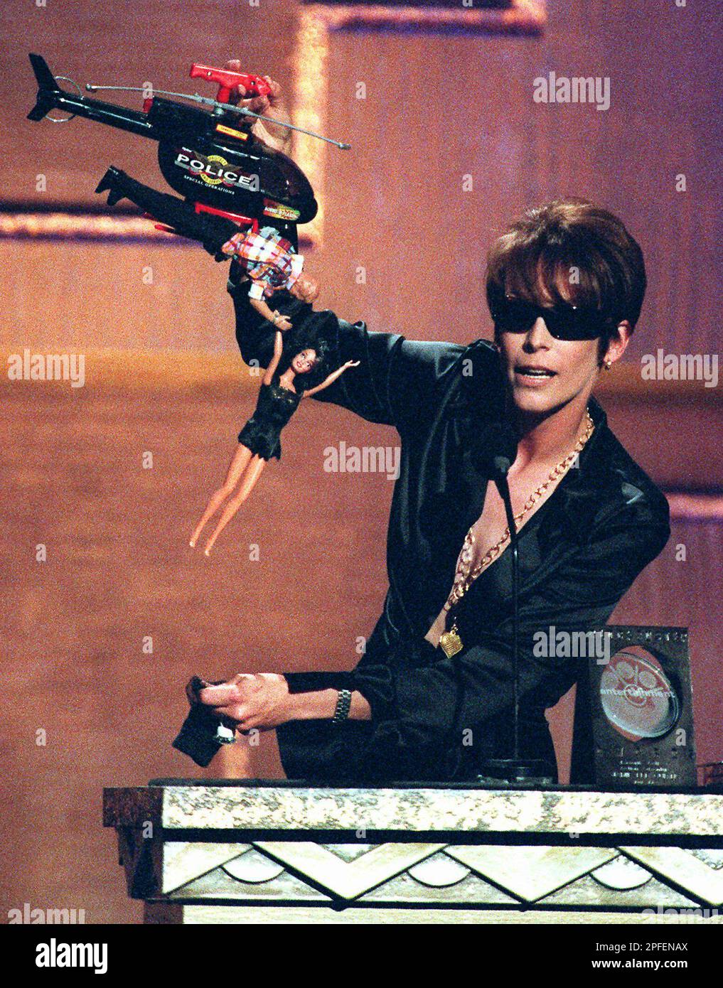 Actress Jamie Lee Curtis displays a toy model of a stunt that was used ...