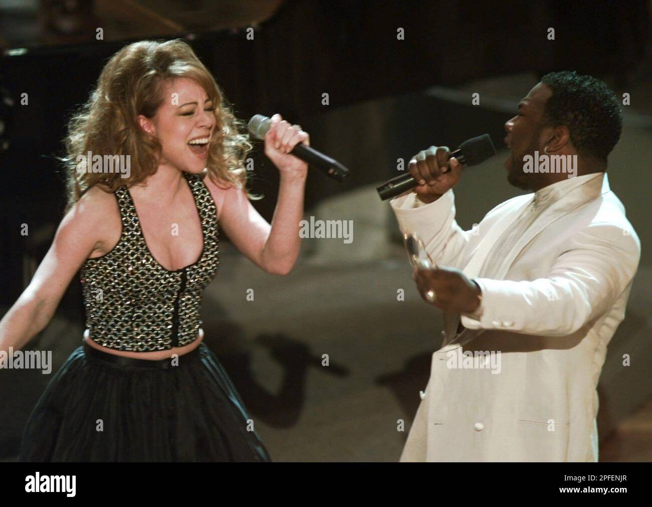Mariah Carey performs the opening song with Wanya Morris of the group ...