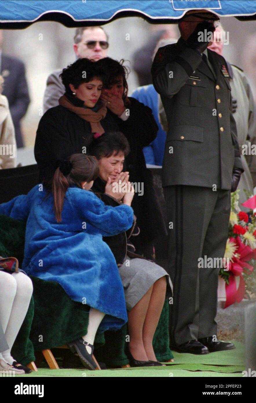 Miriam Dugan, seated, is consoled by daughter Dixie, 8, during the ...