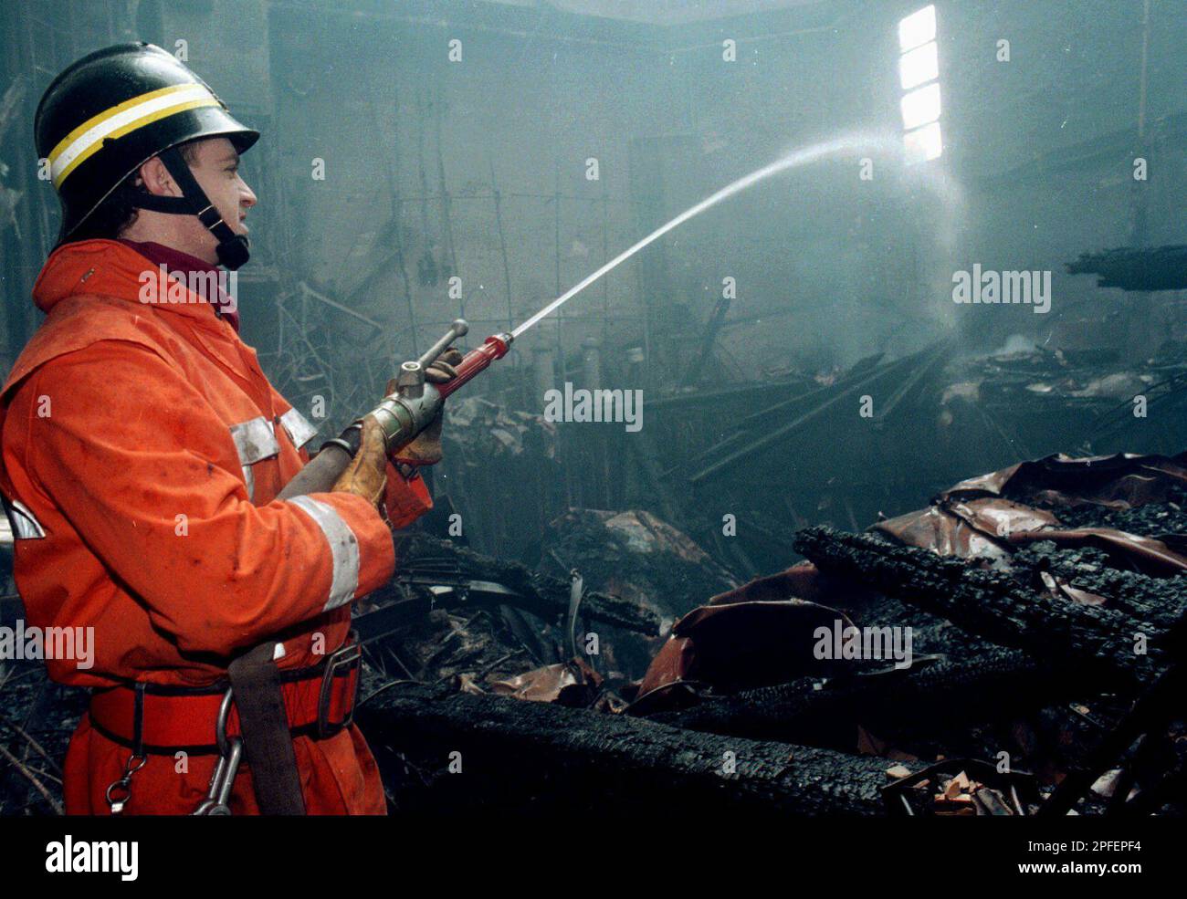A firefighter hoses down Tuesday, Jan. 30 1996 the gutted remains of ...