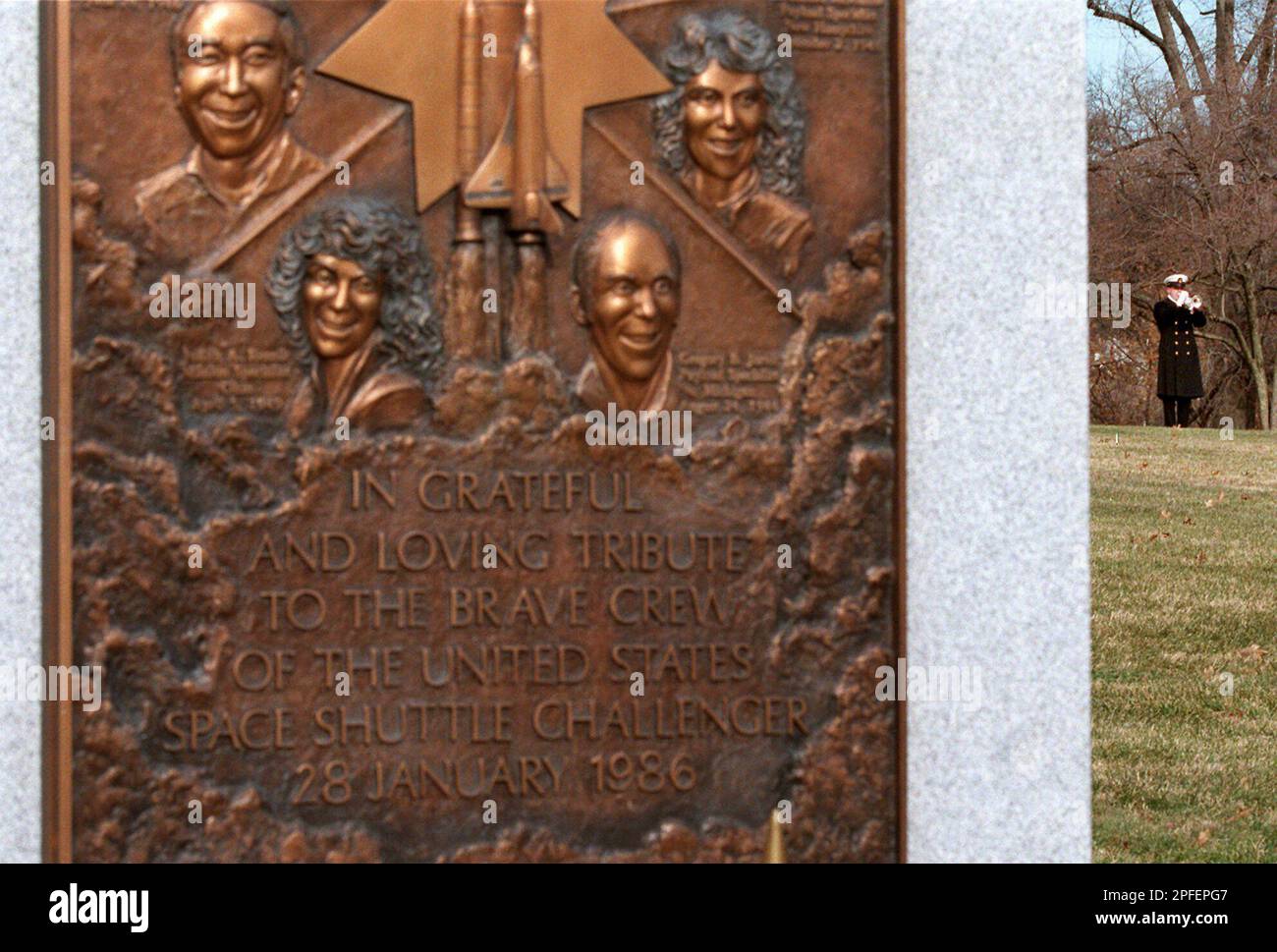 A Navy bugler plays taps on a hill near the Challenger Memorial Plaque ...