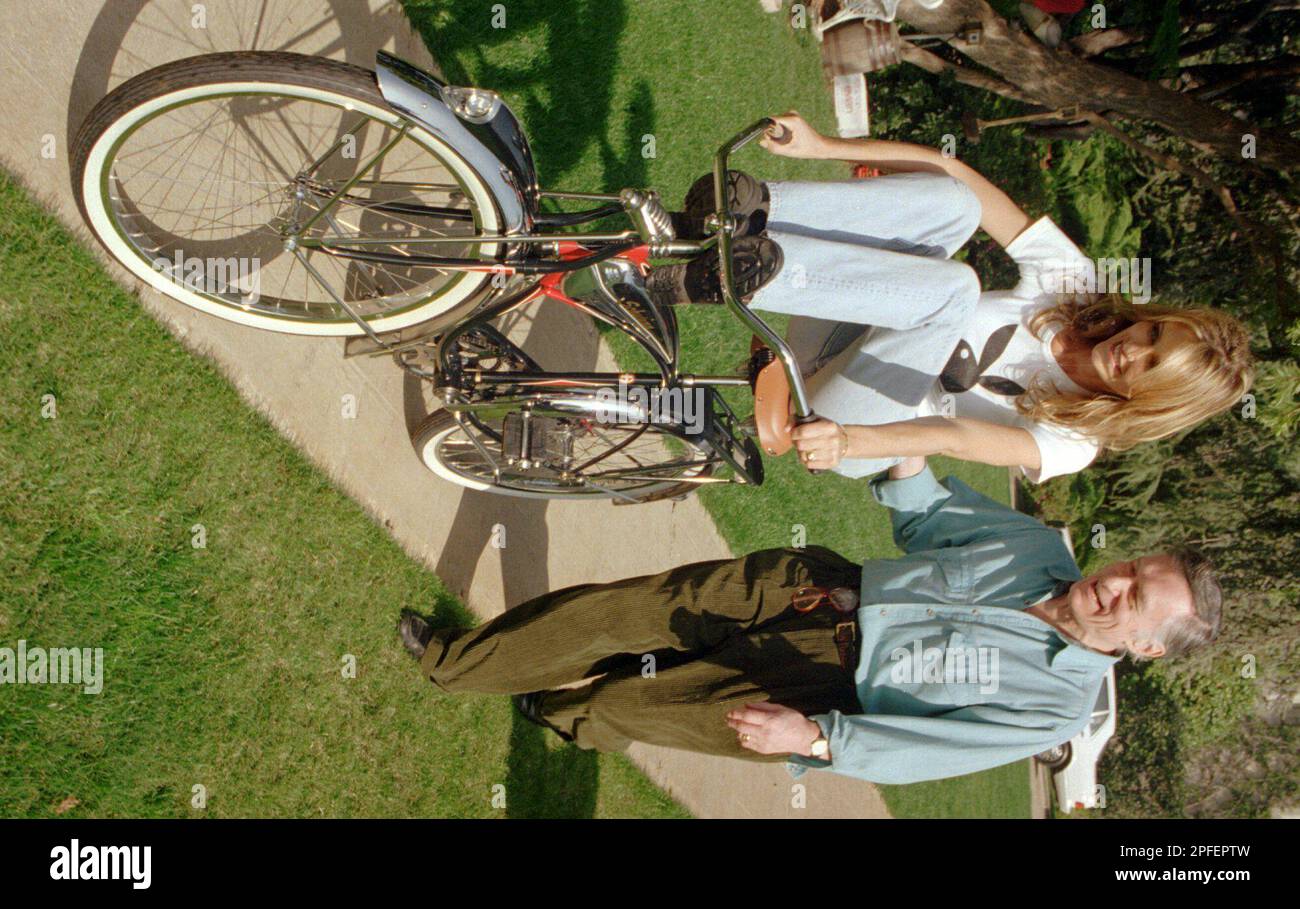 Playboy founder Hugh Hefner pushes his wife, Kimberly, on Schwinn's ...
