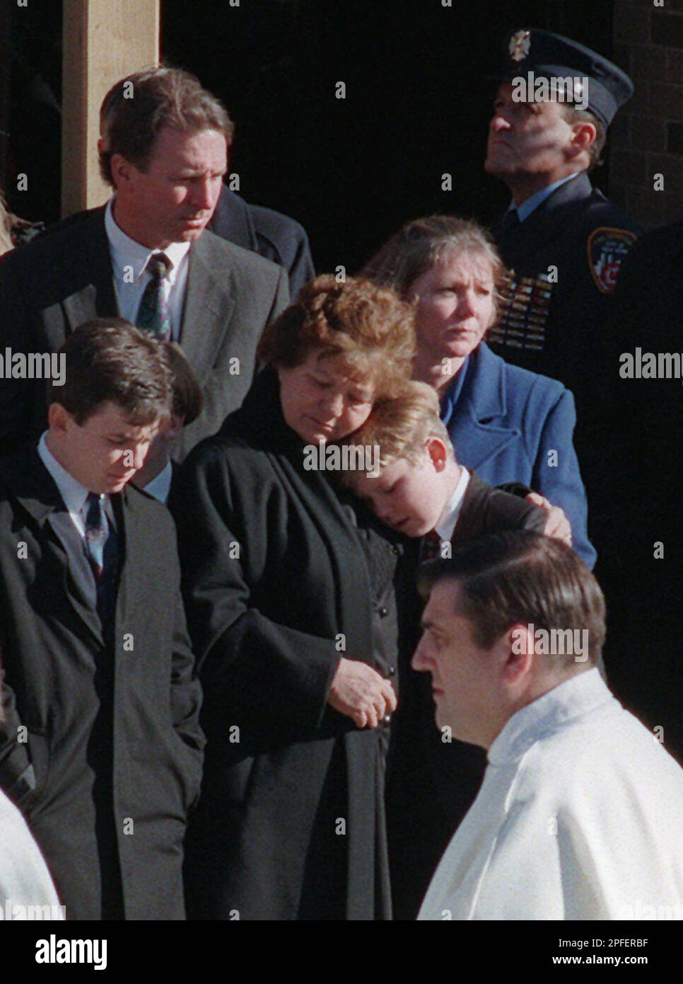Mourners console each other at the funeral of New York City Fire Lt ...