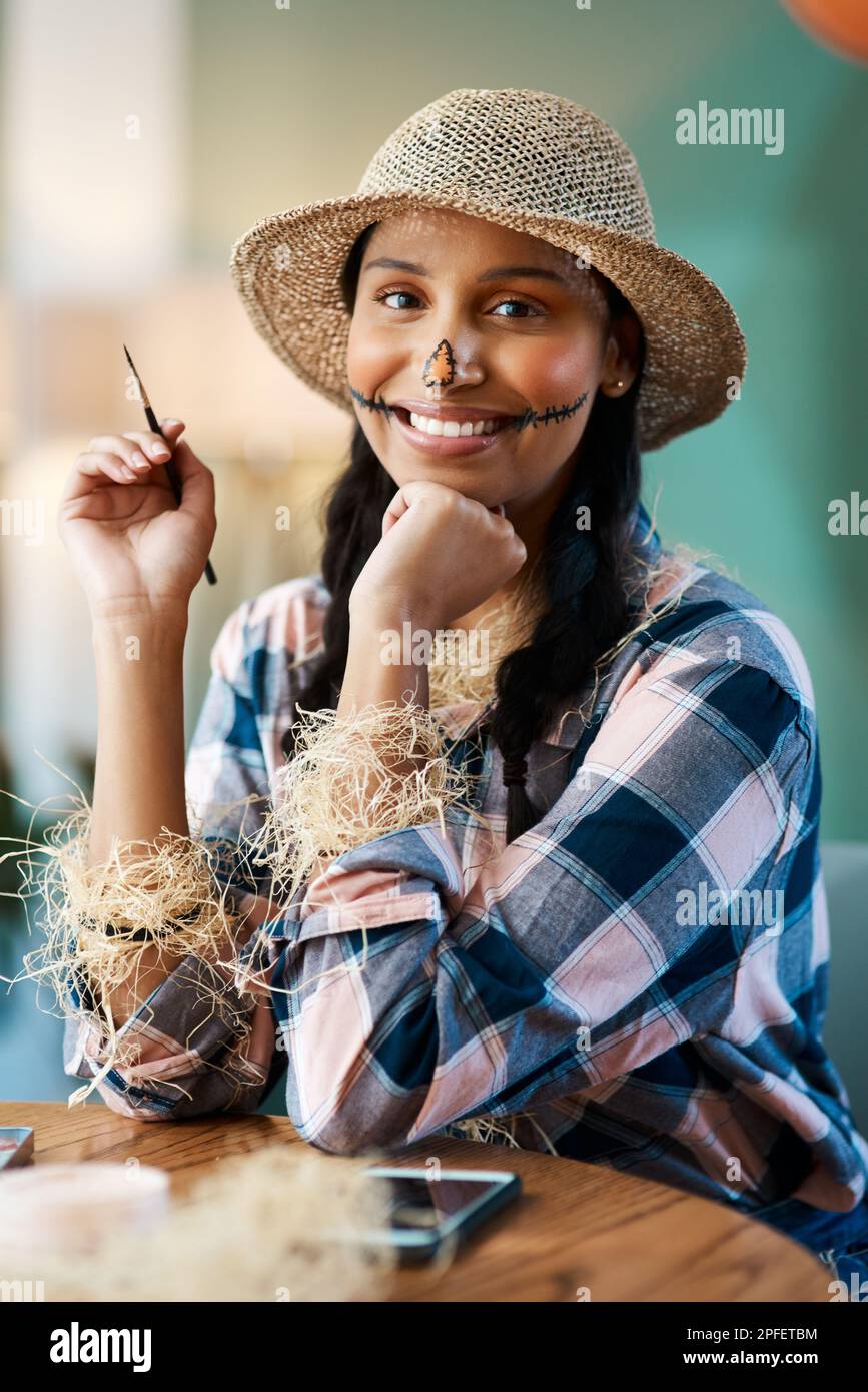 Unleashing my inner scarecrow. a young woman applying halloween makeup ...
