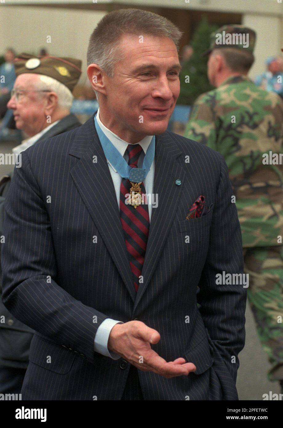 Wearing his Medal of Honor, retired Army Capt. and President of the ...
