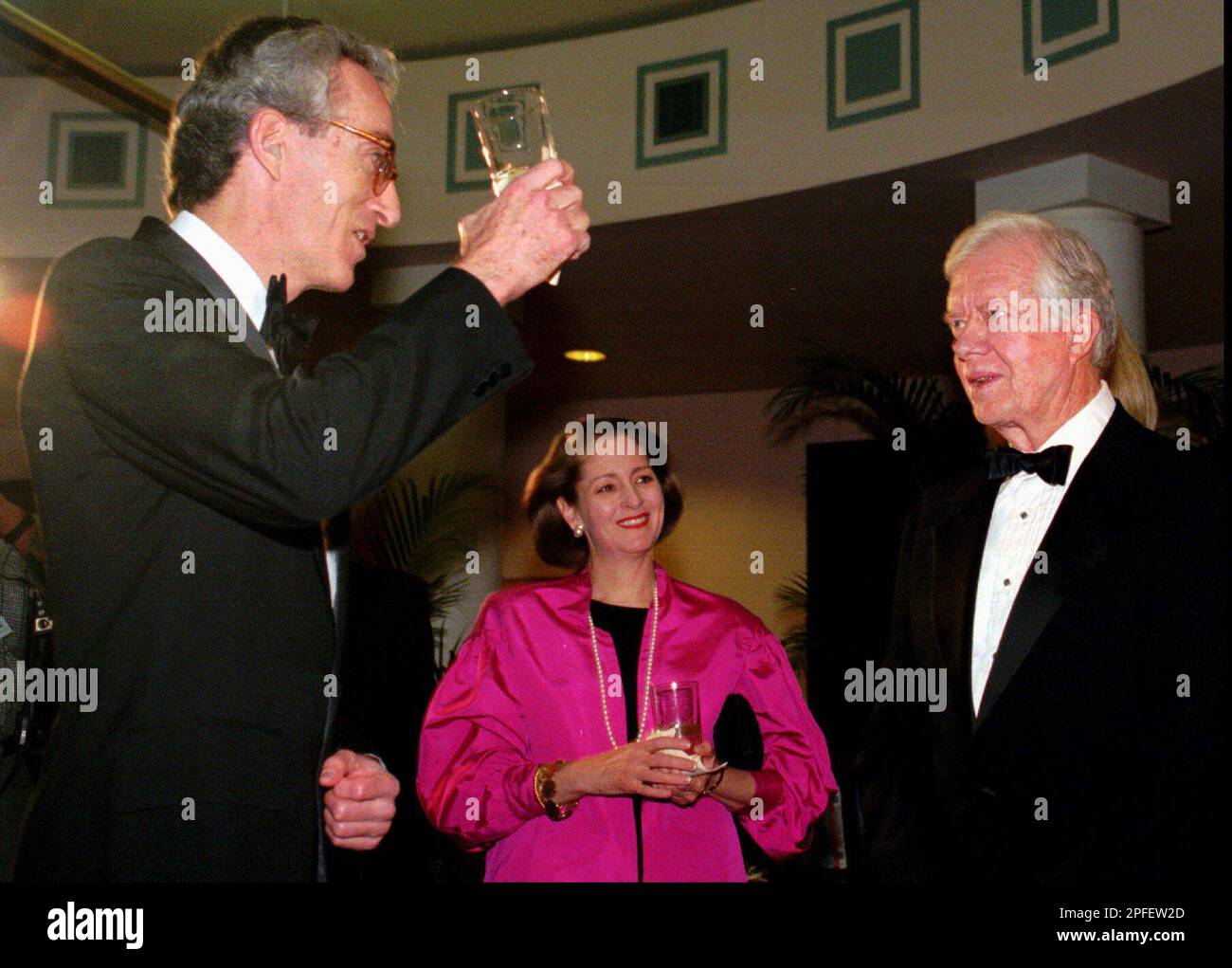 Peter Bell, left, president and CEO of CARE, proposes a toast to former ...