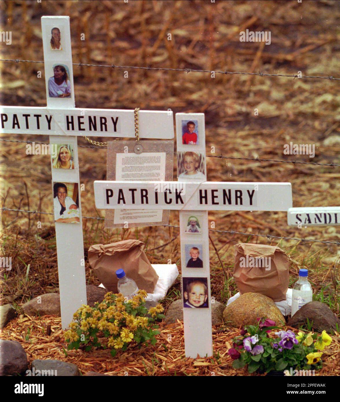 Sack lunches and bottled water sit next to two of the crosses at the ...