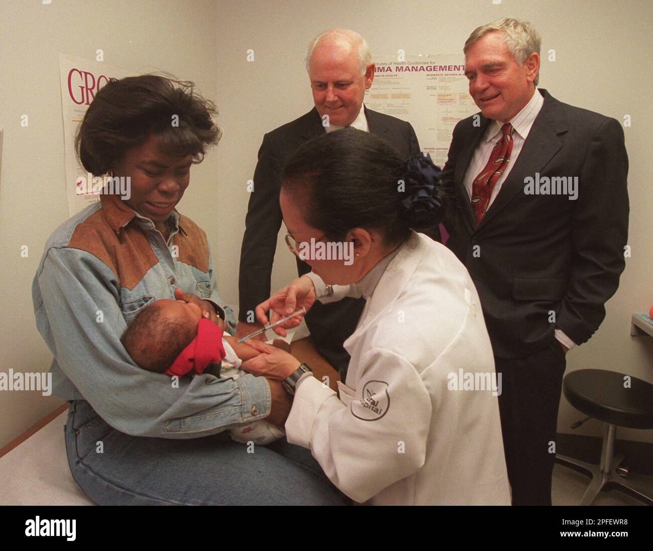 Valerie Gibson, left, winces as Dr. Myrnt M. Than-Tin gives her 2-month ...