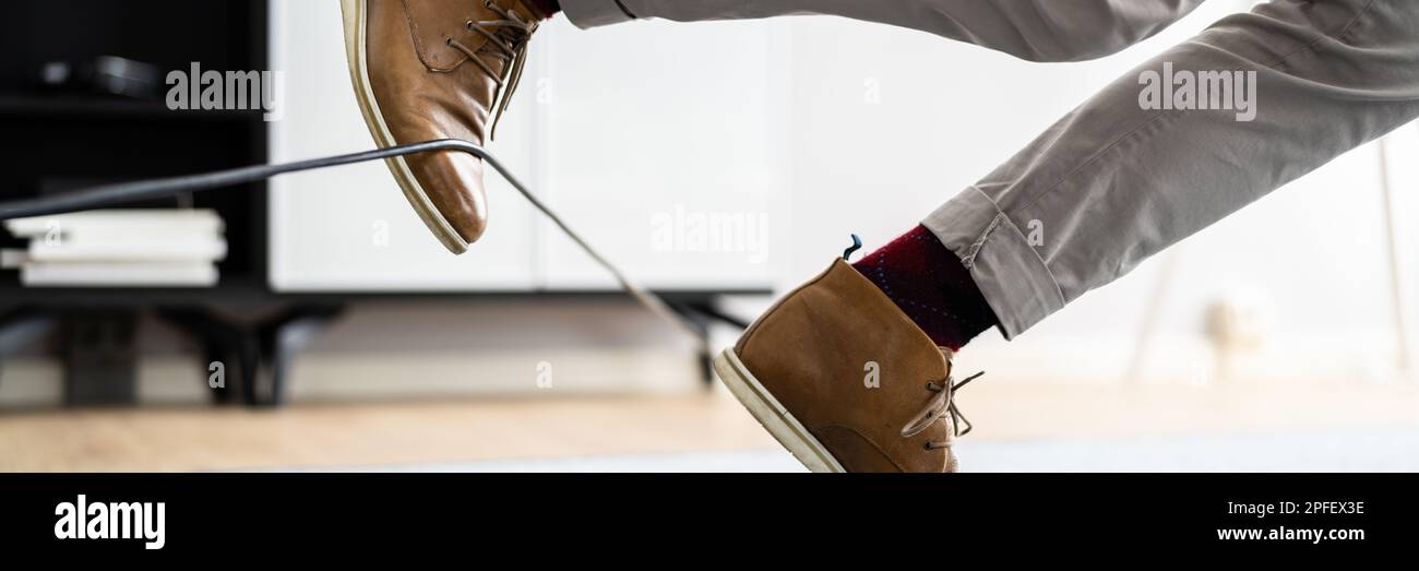 Wire Cord Trip Over And Fall. Feet Stumble On Cable Stock Photo - Alamy