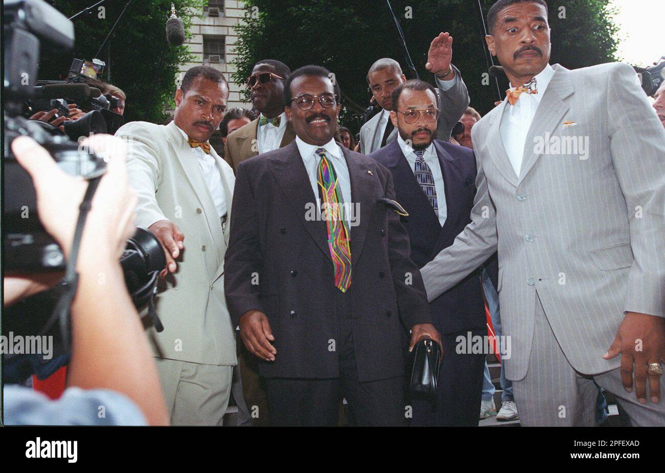 Defense attorney Johnnie Cochran Jr., center, is escorted through the ...