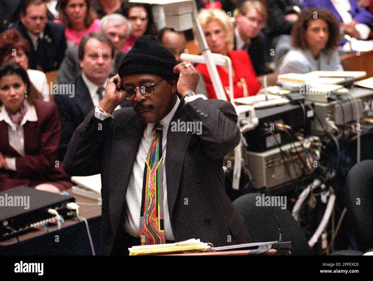 Defense attorney Johnnie Cochran Jr. puts on a knit ski cap Wednesday ...
