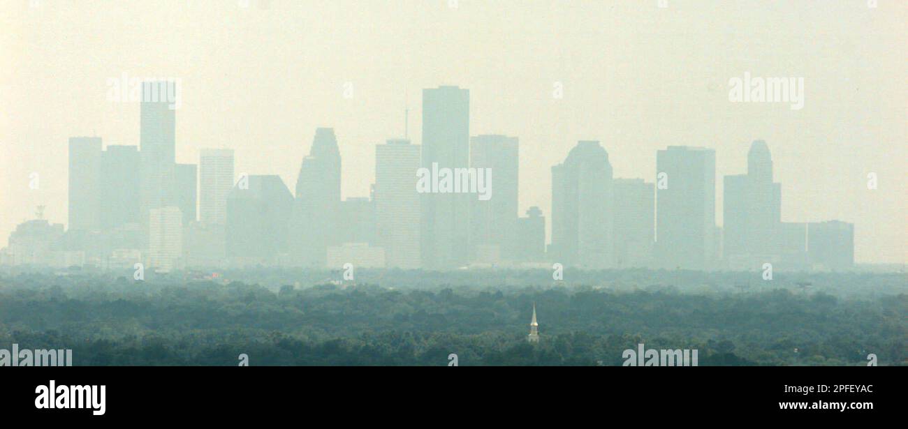 Downtown Houston is covered in a shroud of haze in the afternoon, as ...