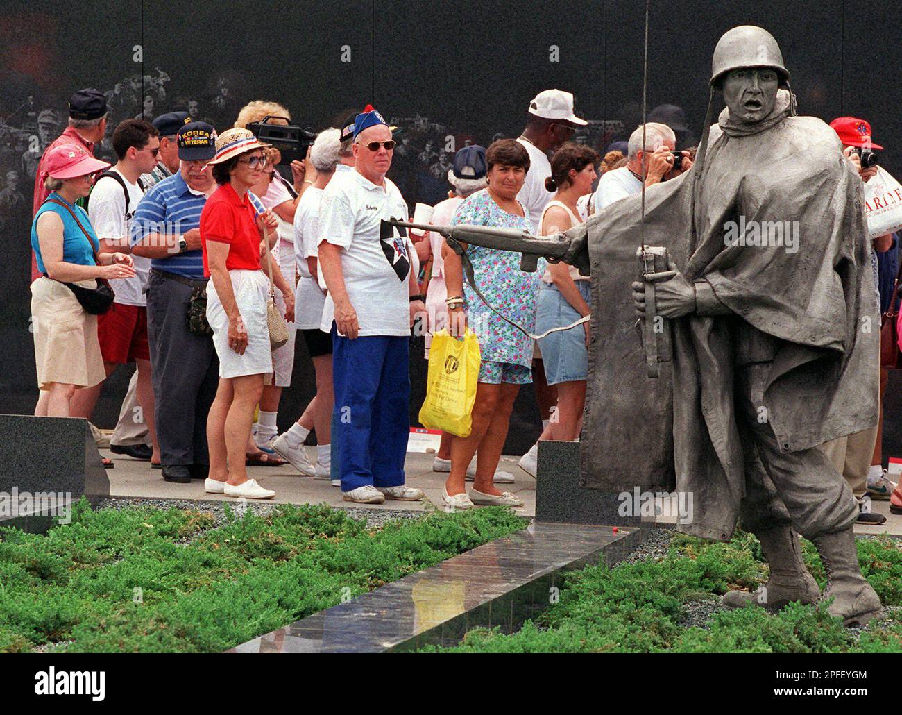 Visitors walk through the Korean War Veterans Memorial walk through the ...