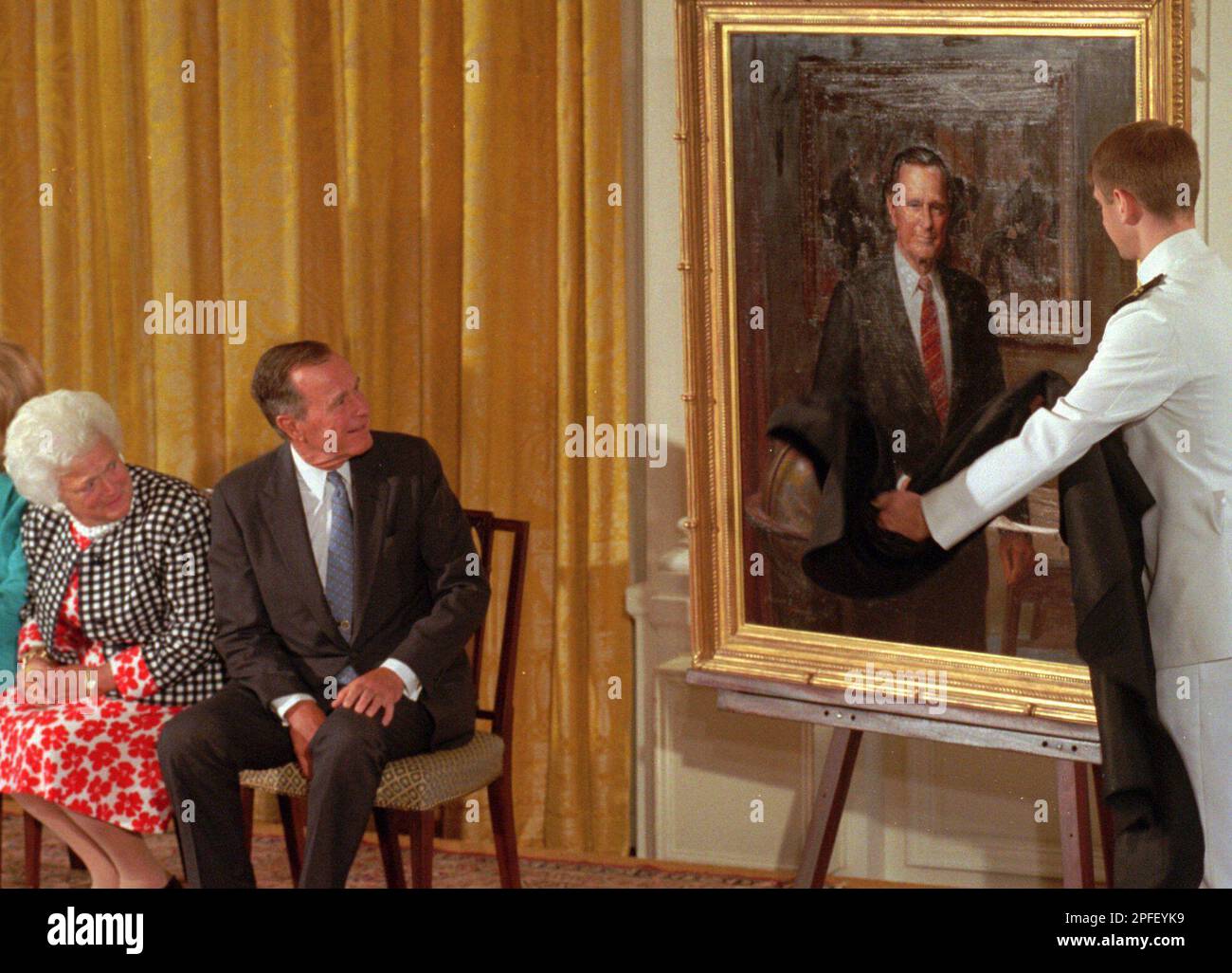 Former President and Mrs. Bush look on as his formal portrait is ...