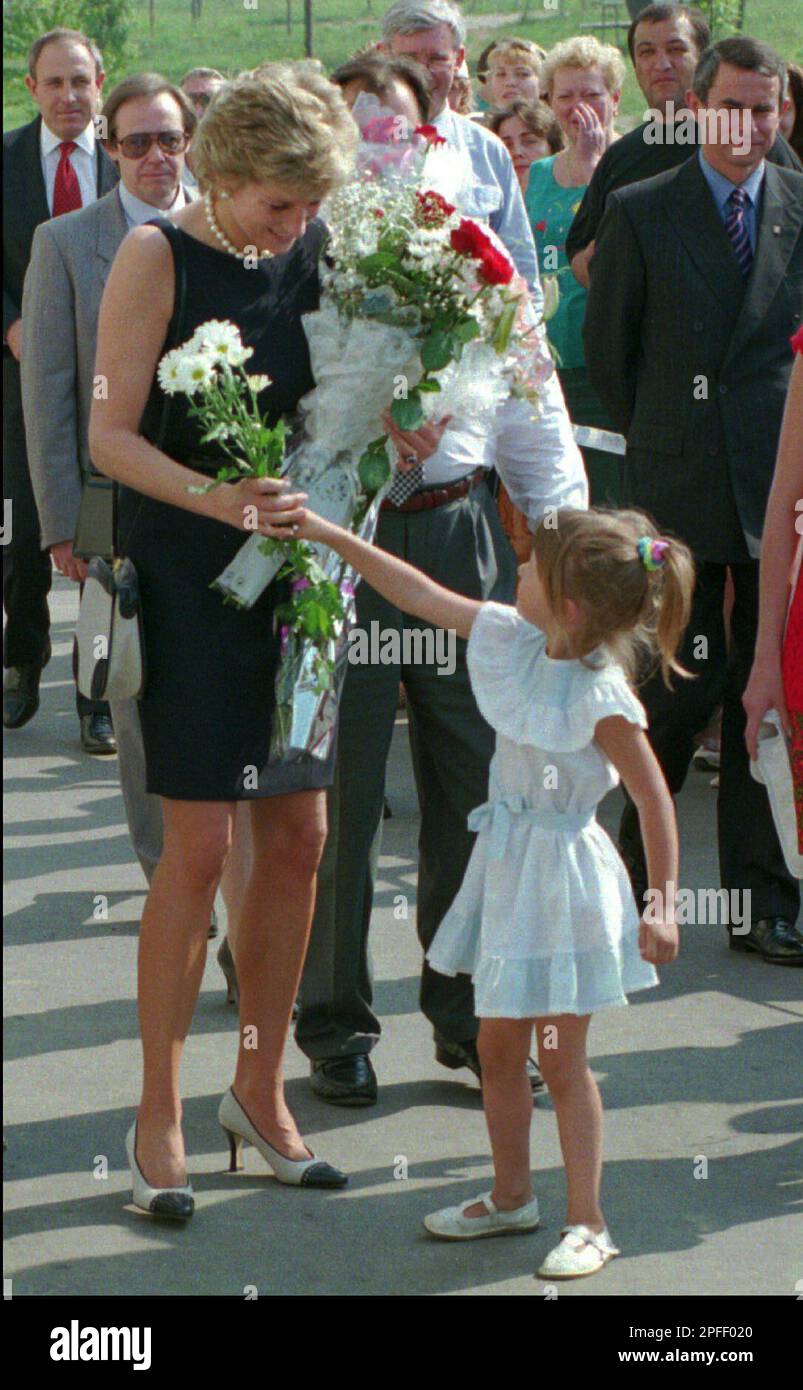An unidentified young Russian girl presents the Princess of Wales with ...