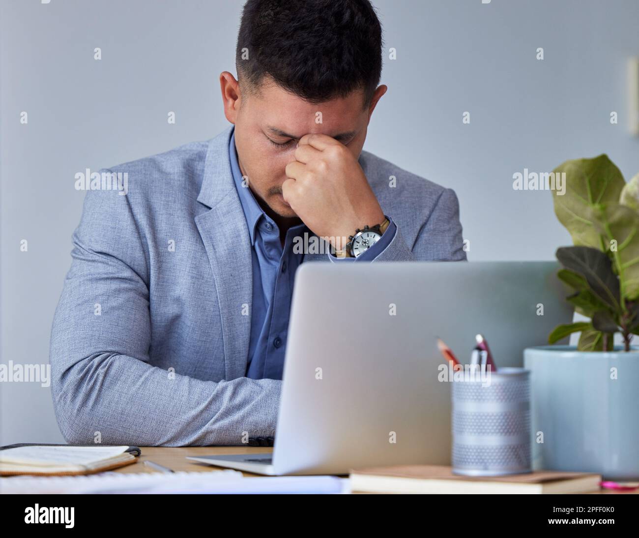 I cant believe this headache is coming now. a young businessman ... I cant believe this headache is coming now. a young businessman ...